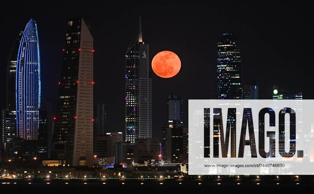 BEIJING, The moon rises behind the skyline of Kuwait City, Kuwait ...