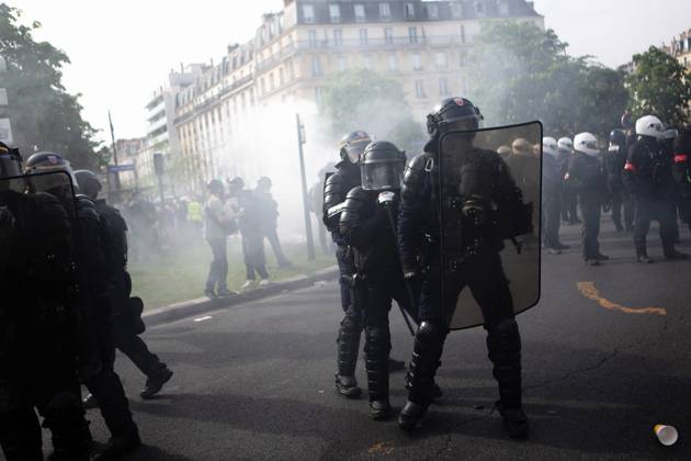 Anit-Capitalists protest in Paris. A protester flees as riot police ...