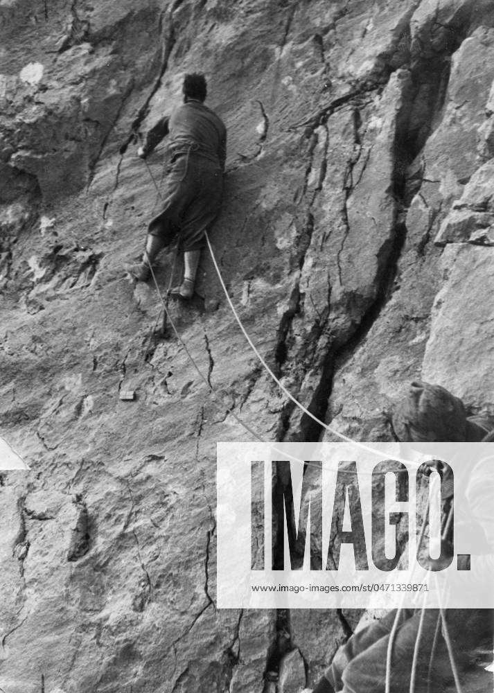ROCK CLIMBERS Rock climbing with ropes and pegs. Date
