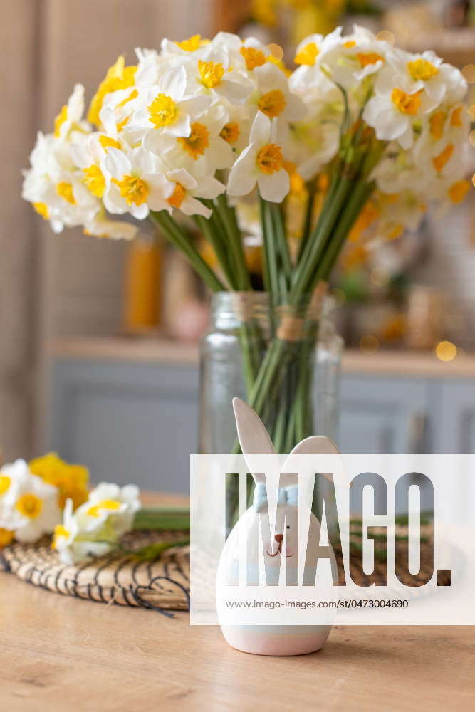 A ceramic figurine of a cute striped hare stands on the kitchen table ...