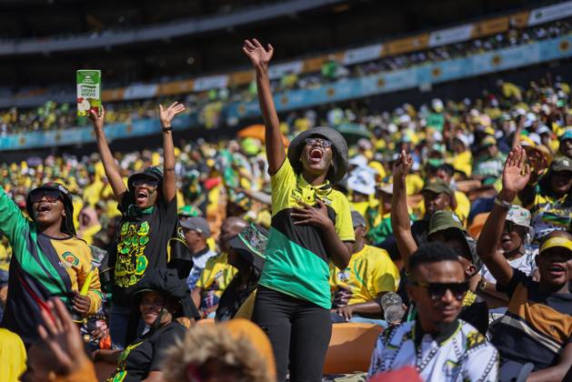 Fans and supporters chant and wave flags during the final African ...