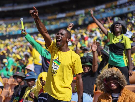 Fans and supporters chant and wave flags during the final African ...