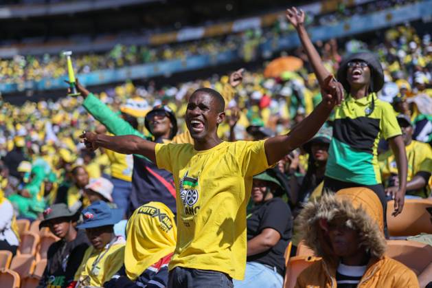 Fans and supporters chant and wave flags during the final African ...