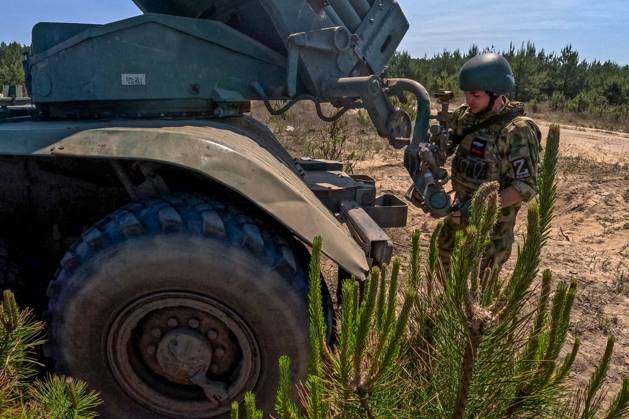 RUSSIA, KHERSON REGION - : A crewman handles a BM-21 Grad multiple ...