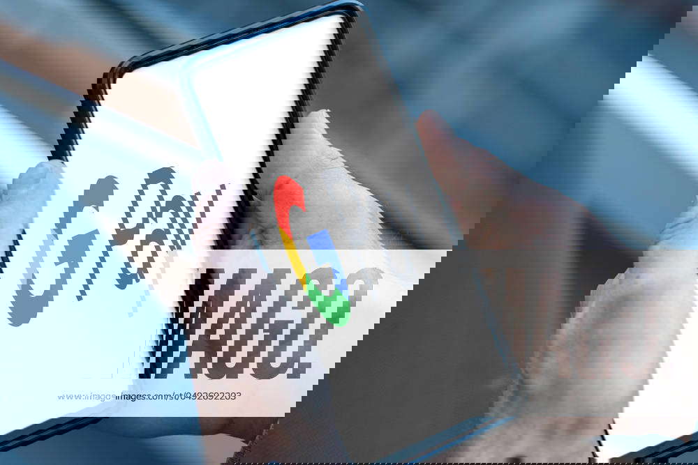 : Mobile phone or smartphone in the hand of a man who opens the GPay or ...