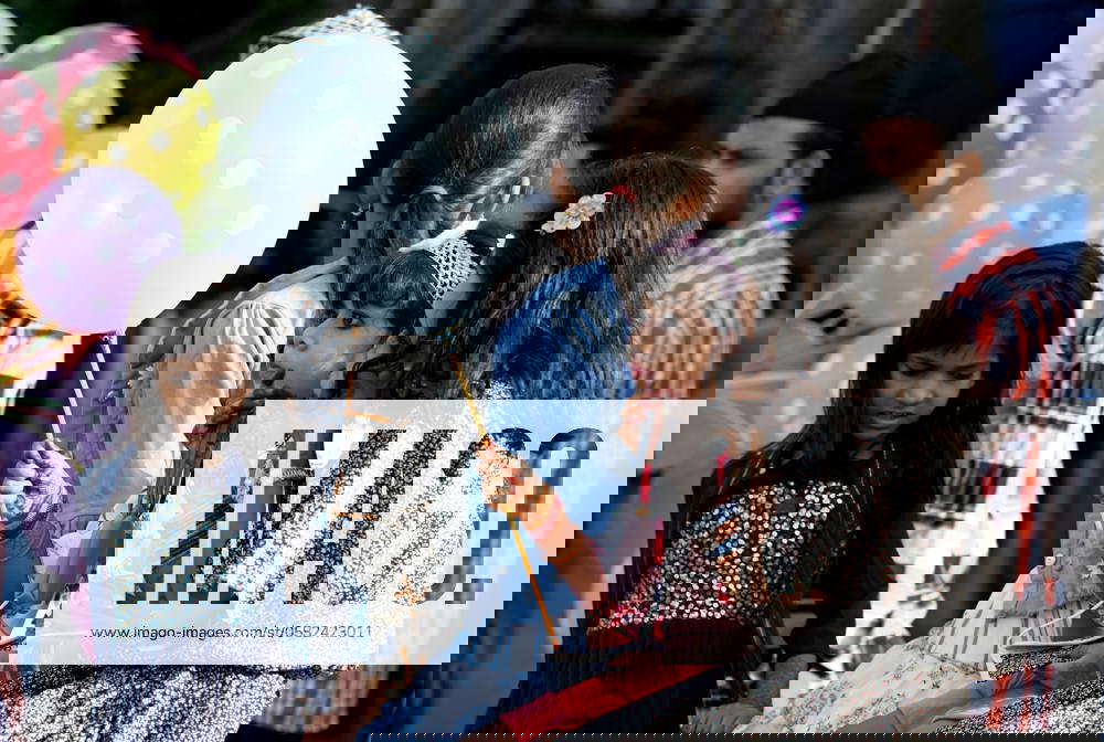 NOIDA, INDIA - JUNE 17: Children buying balloons outside the Jama Masjid in Sector 8 on the