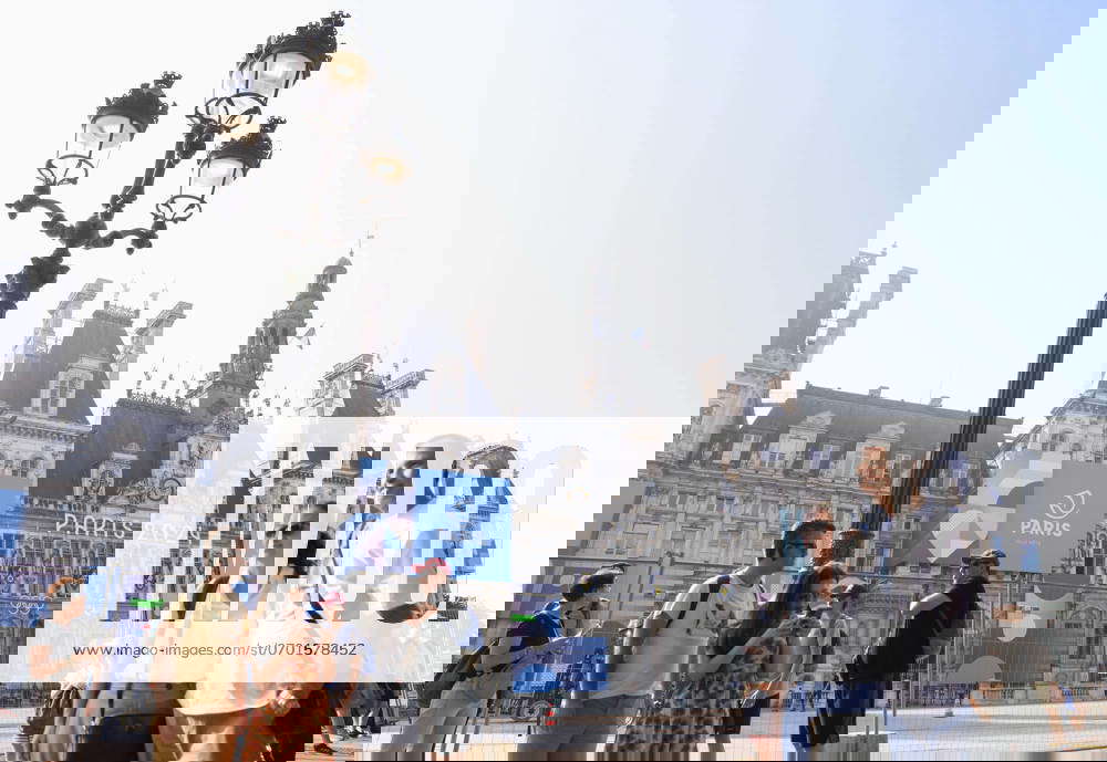 Scene ahead of Paris Olympics People walk past Paris city hall ...