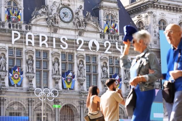 Scene ahead of Paris Olympics People walk past Paris city hall ...