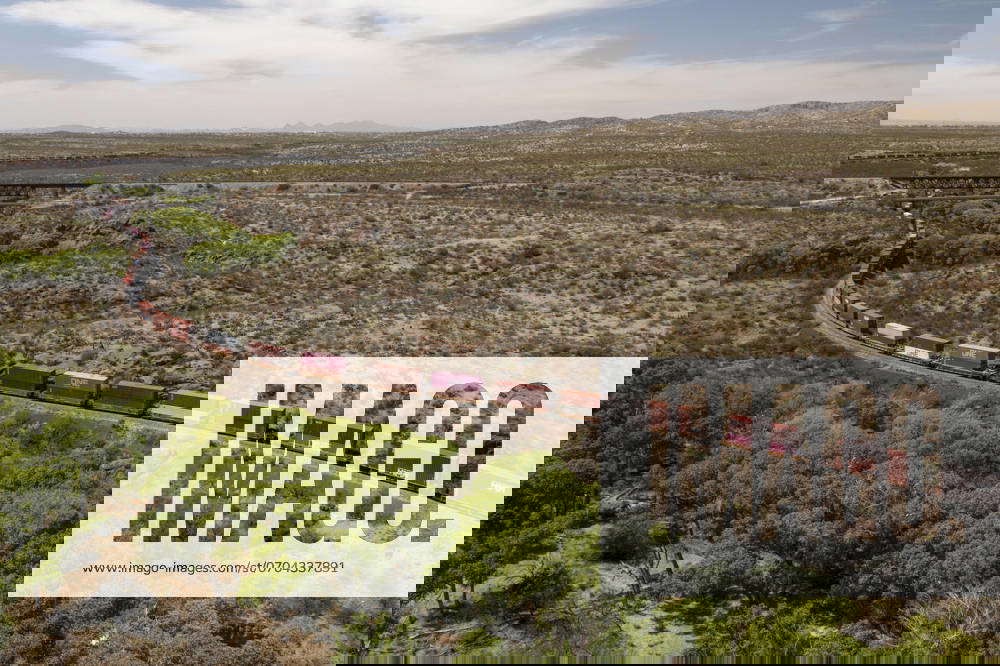 Aerial view of long container stack trains winding around curves United ...