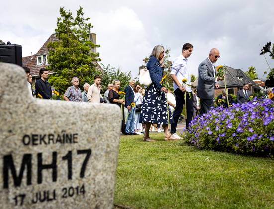 HILVERSUM - Relatives lay flowers during a memorial meeting for the victims of the MH17 air