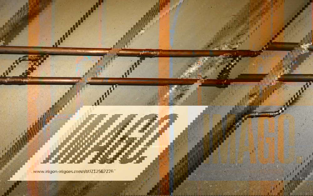 Exposed copper pipes in a network on a wall. Pipework,United States ...