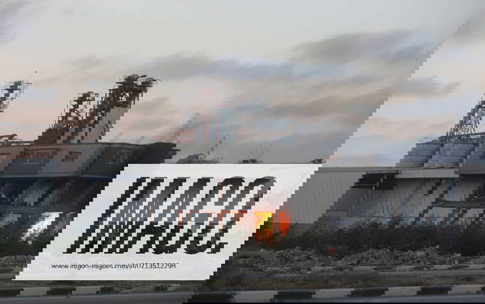 Palestinians inspect the area following an attack by the Israeli army ...