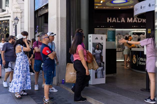 Madrid, Spain: A group of people queue to enter the official Real ...