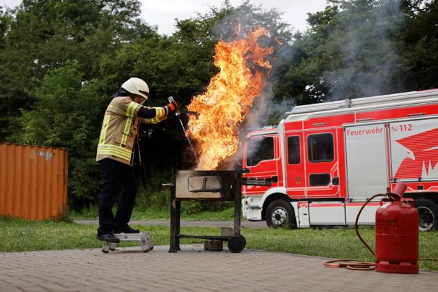 A firefighter demonstrates the dangers of fire accelerants on a ...