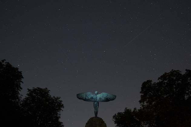 Berlin, Germany: Meteors from the Perseids meteor shower fall behind a ...
