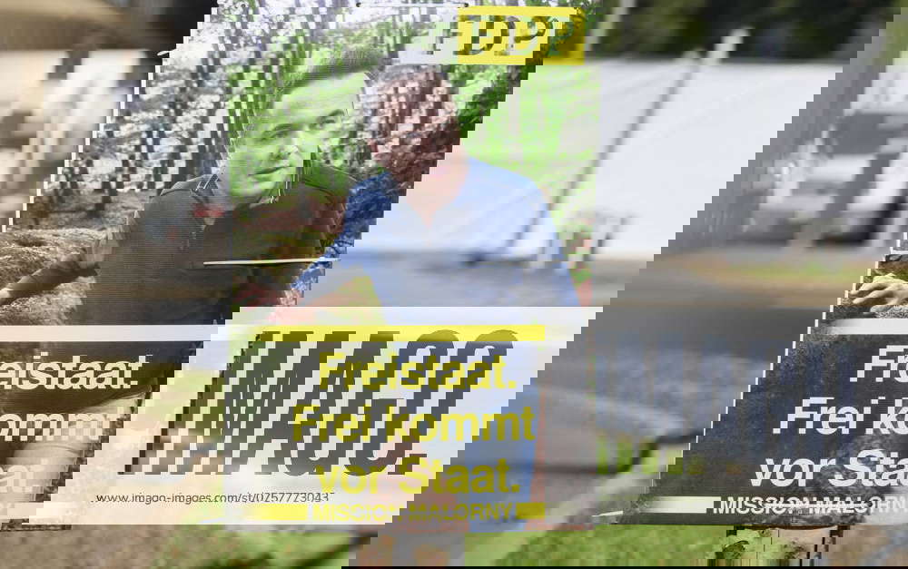 An election poster for the FDP party is attached to a street lamp ...