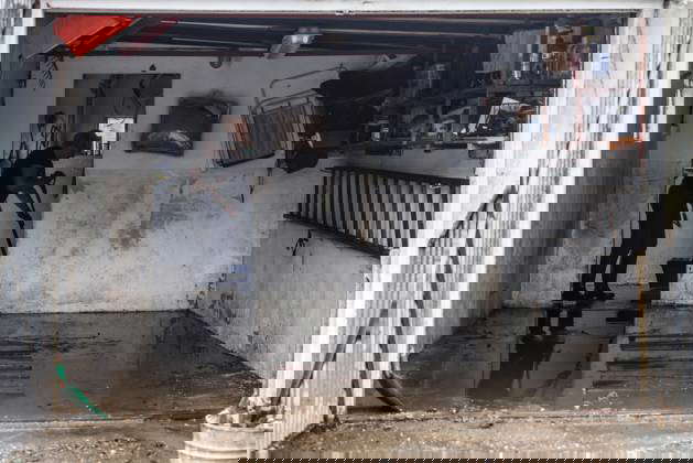 Flood Aftermath In Poland A man is cleaning a house which was damaged ...