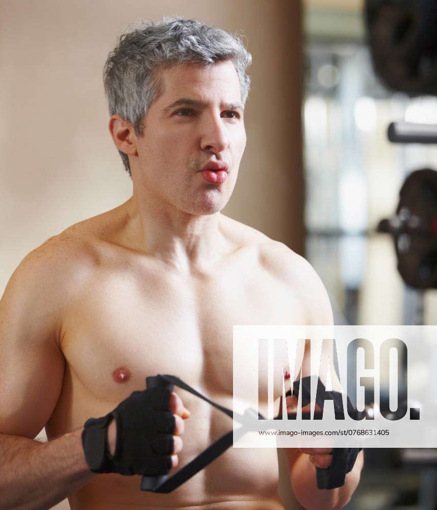 Breath, fitness and mature man with a cable row machine, exercise and ...