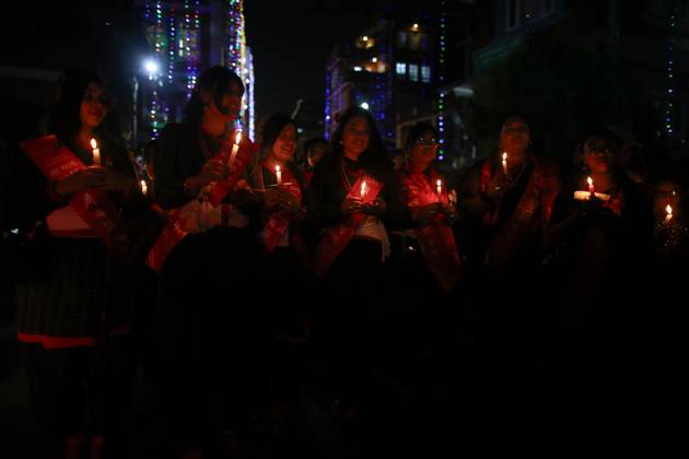 Lalitpur, Nepal: Women in traditional attire hold candles as they ...