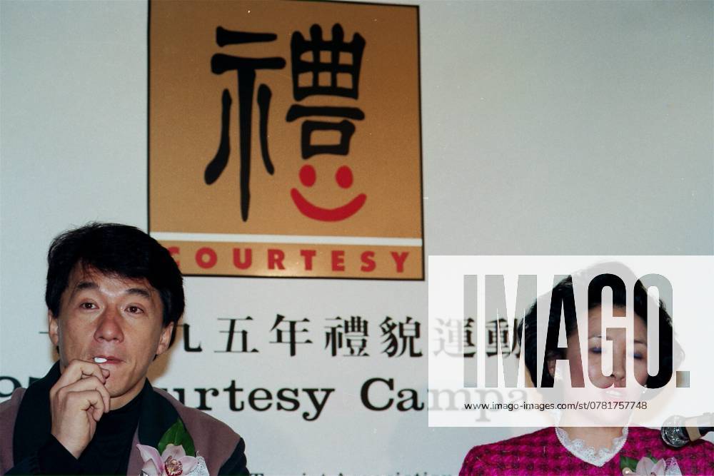 Movie star Jackie Chan puts a chewing gum into his mouth sneakingly ...