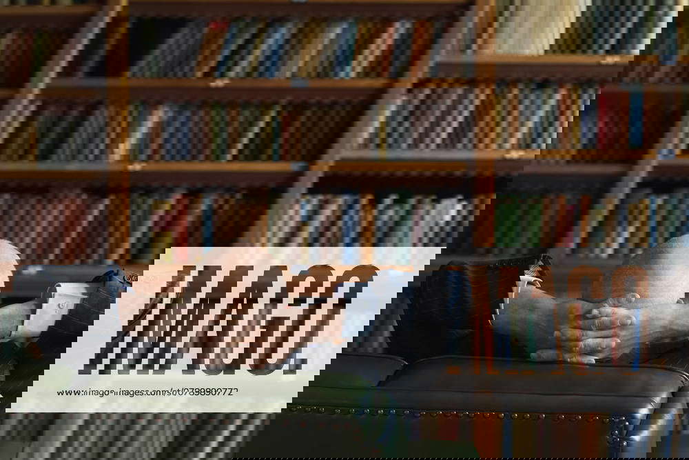 Businessman Sitting in Library hands behind head, 33027612, Whites ...