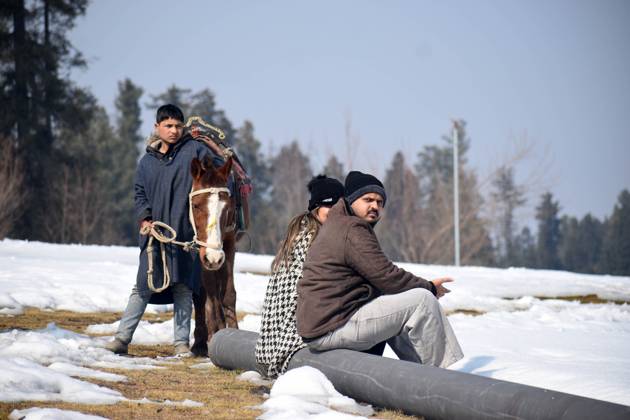Tourists taking horseback riding on the snow-covered mountains at ...