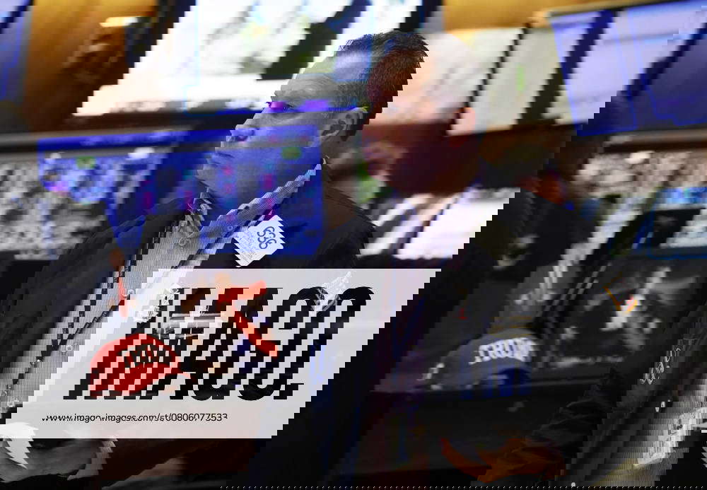 President Donald Trump branded hats hang as traders work on the floor ...